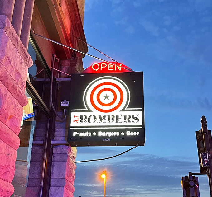 As dusk falls, the neon sign glows like a beacon for burger enthusiasts, promising "P-nuts, Burgers, Beer"&mdash;the holy trinity of comfort food.