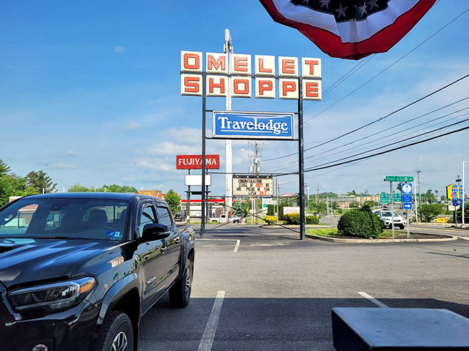 That vintage sign has guided hungry travelers for decades – a retro landmark promising that breakfast salvation is just one exit away.