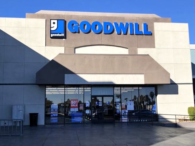 The iconic blue Goodwill sign stands against the desert sky, a beacon for bargain hunters and sustainability champions alike.