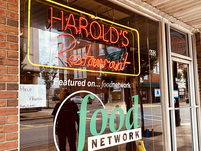 That neon sign isn't just announcing a restaurant—it's a beacon of hope for hungry travelers and a reminder that Food Network stars know where the real treasures are found.