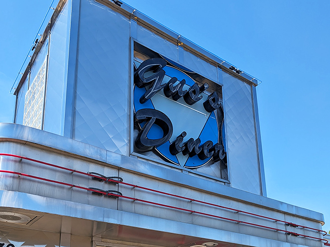 The neon sign glows like a beacon for hungry travelers. More than letters&mdash;it's a promise of comfort food that will hug your insides like a warm blanket.