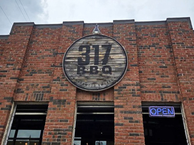 The weathered wooden sign against brick announces your arrival at barbecue headquarters &ndash; like a meaty North Star guiding hungry travelers home.