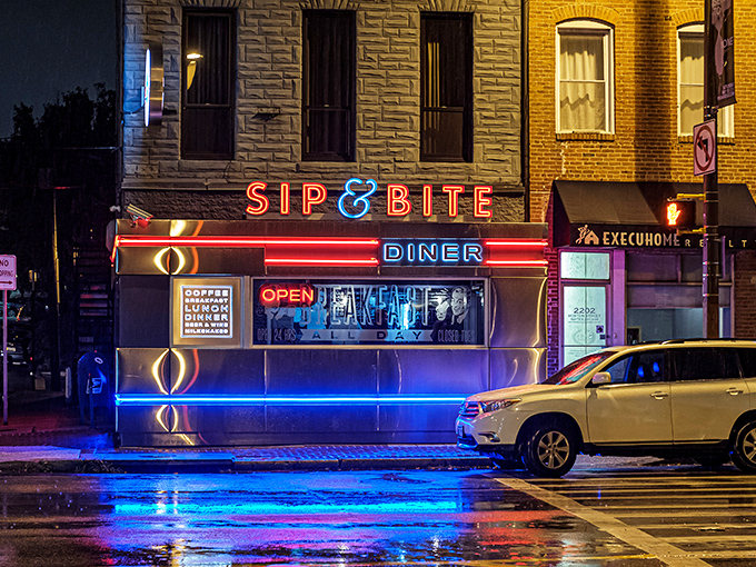 At night, Sip & Bite's neon glow transforms an ordinary street corner into an Edward Hopper painting with better food options and friendlier service.