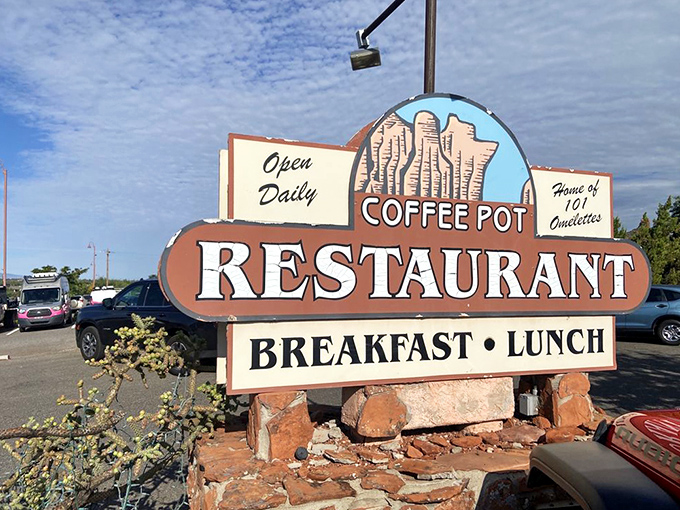 The roadside sign promises exactly what you need: breakfast, lunch, and 101 reasons to pull over immediately.