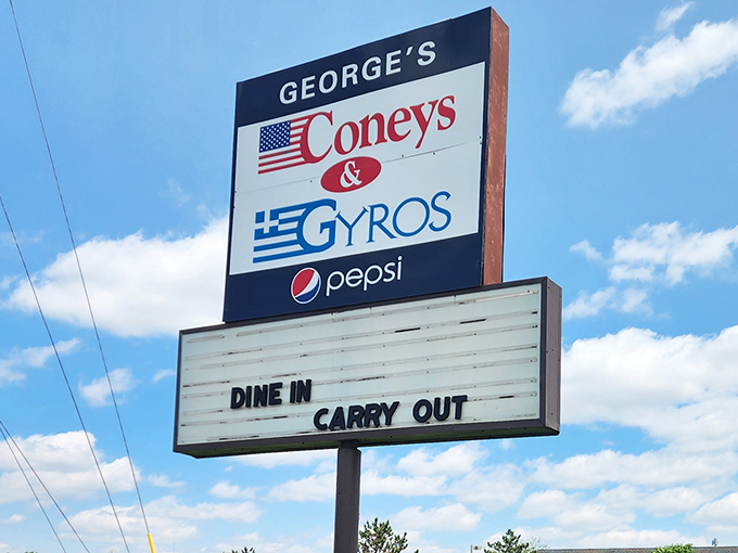 The roadside sign proudly flying both American and Greek flags&mdash;a perfect symbol of the cultural fusion that makes this food so irresistibly special.