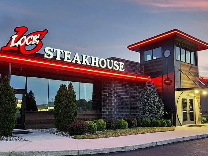 As dusk falls, the neon sign glows like a beacon for hungry travelers. The architectural equivalent of "come on in, the steak is fine."