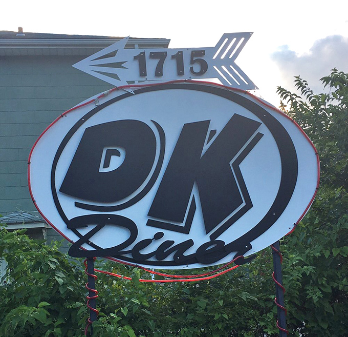 The iconic DK Diner sign, pointing the way to happiness like a neon North Star for hungry travelers.