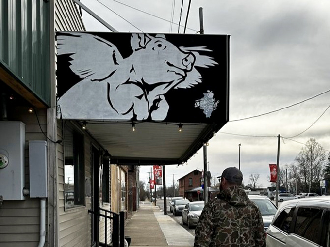 That iconic flying pig silhouette against a moody sky—a beacon of hope for hungry travelers on the barbecue trail.