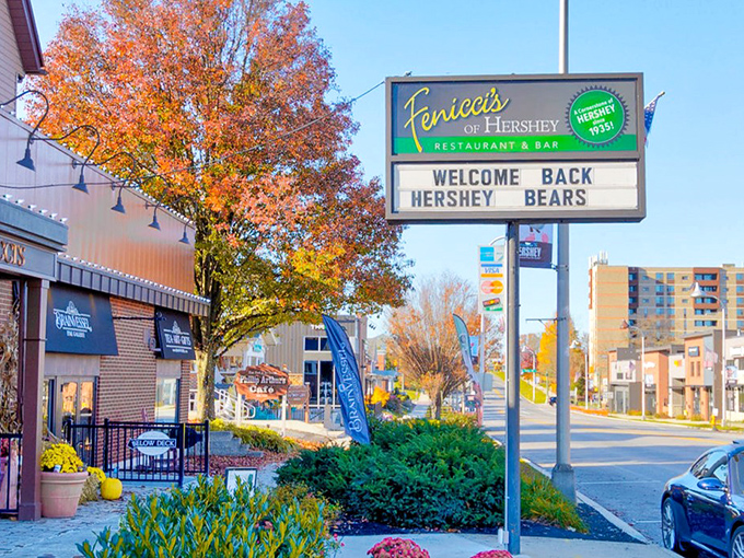 The iconic Fenicci's sign stands tall against autumn foliage, welcoming hungry visitors and local hockey fans alike.