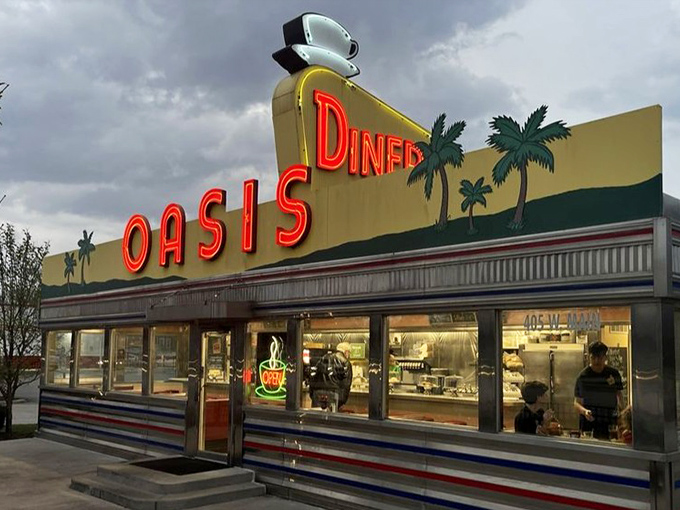 The illuminated sign promises what every weary traveler seeks &ndash; an oasis of coffee, comfort food, and conversation in a desert of chain restaurants and drive-throughs.