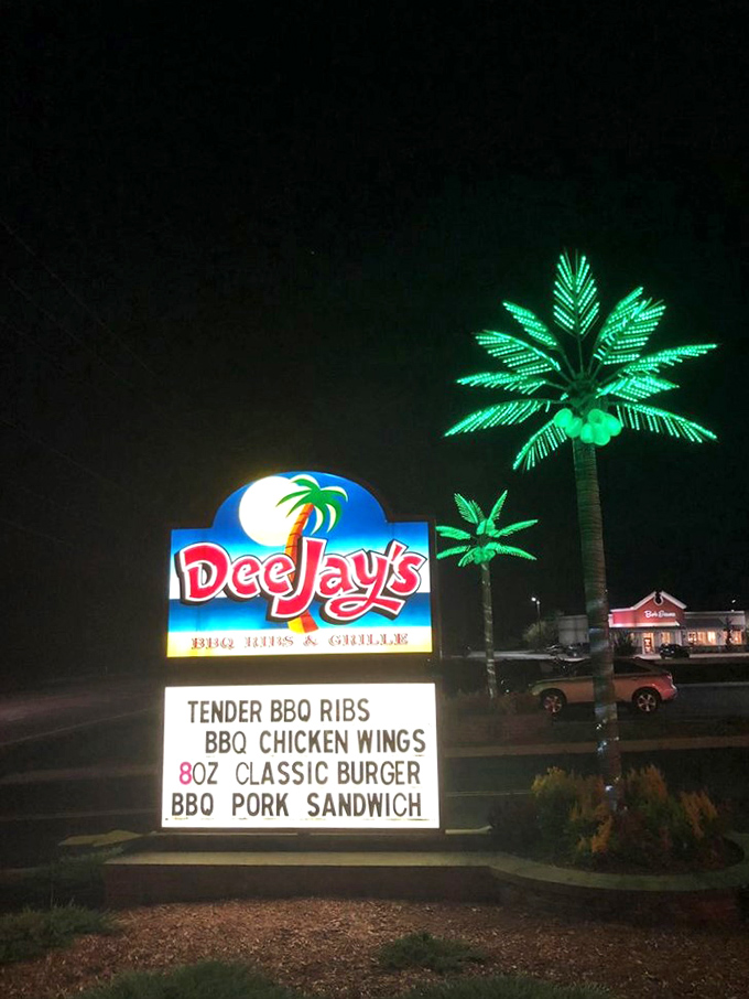 The nighttime signage glows like a neon promise. That illuminated palm tree isn't just decoration&mdash;it's a beacon of barbecue hope in the darkness.