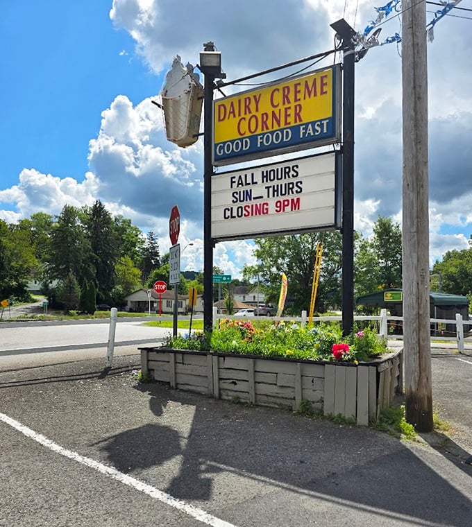 The roadside sign stands tall, featuring an ice cream cone that's practically waving you in. Those fall hours mean summer's pleasures linger just a little longer.