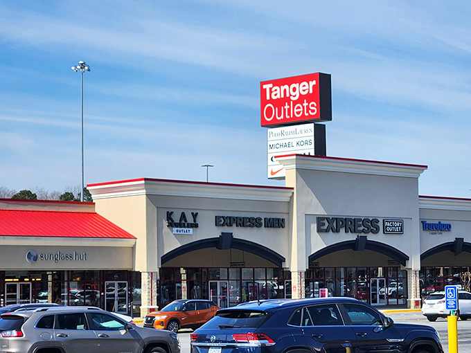 The Tanger Outlets sign stands tall against Georgia's blue sky, a beacon of hope for credit cards about to be exercised.