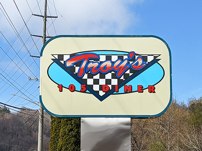 The roadside sign stands as a beacon of hope for hungry travelers &ndash; its checkered background promising that yes, you've found the real deal, not some chain restaurant imposter.