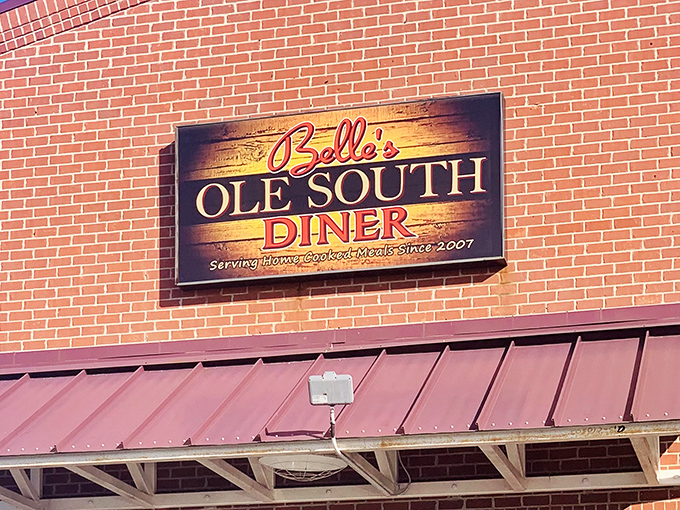 The sign glows against red brick like a Southern sunrise, announcing to hungry travelers that breakfast salvation awaits just beyond those doors.