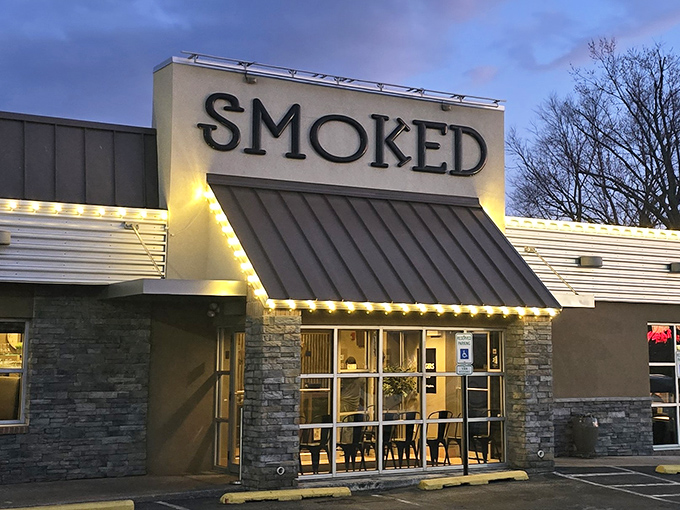 As evening approaches, the illuminated Smoked sign serves as a barbecue lighthouse, guiding the hungry home to brisket salvation.