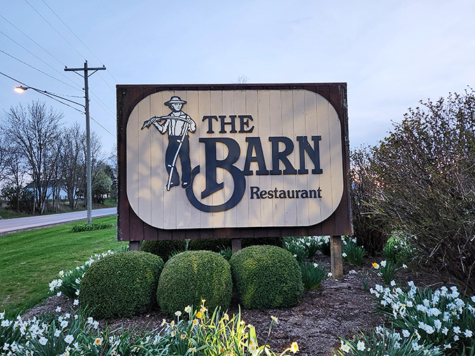 The roadside sign promises simple pleasures, surrounded by spring blooms that whisper, "Slow down, good food takes time."