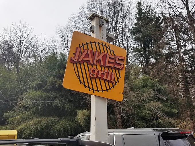 The roadside sign stands tall, a yellow barbecue bat-signal calling to hungry travelers: "Salvation from mediocre meals lies here."