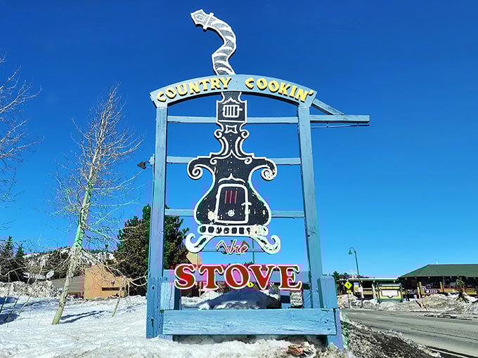 The roadside sign stands like a beacon against Mammoth's blue winter sky, promising warmth, sustenance, and the kind of cooking that makes you miss your childhood.