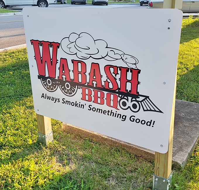 The sign says it all: "Always Smokin' Something Good"&mdash;a railroad-themed promise that delivers with every succulent, smoky bite.