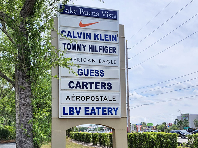 The marquee sign stands as a roadmap to retail paradise, each brand name a promise of treasures waiting to be discovered.