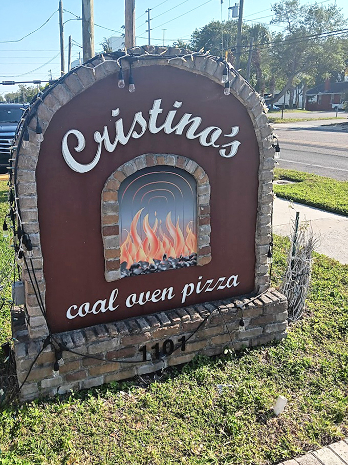The sign says it all&mdash;coal-fired magic happens here. This isn't just restaurant signage; it's a beacon of hope for pizza lovers everywhere.