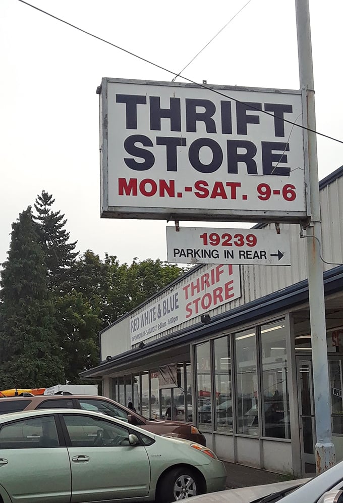 The sign announces business hours like a promise: six days a week of treasure hunting await. The address guides pilgrims to this temple of thrift.