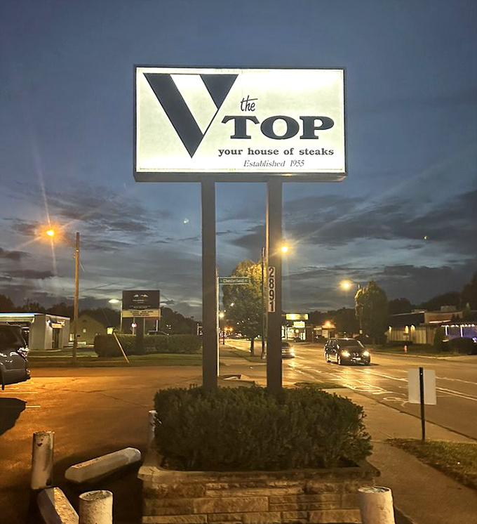 The illuminated sign stands as a beacon in the night, guiding hungry travelers to the promised land of perfect prime rib.
