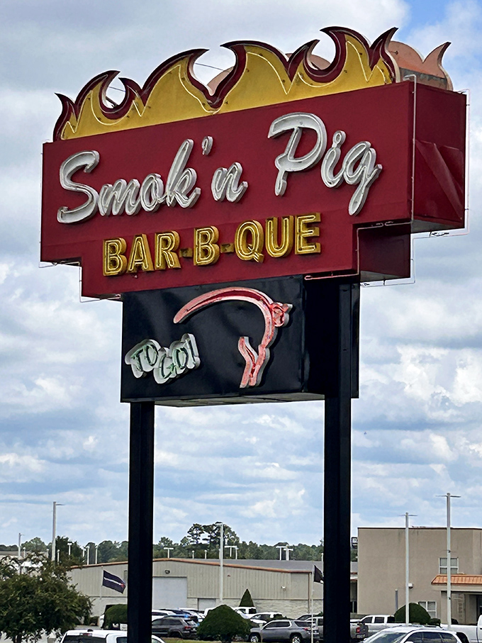 The roadside sign stands tall against the Georgia sky &ndash; a beacon of BBQ hope for hungry travelers and locals alike.