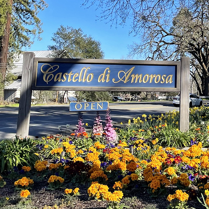 Even the entrance sign gets the royal treatment, surrounded by flowers that would make any castle gardener proud.