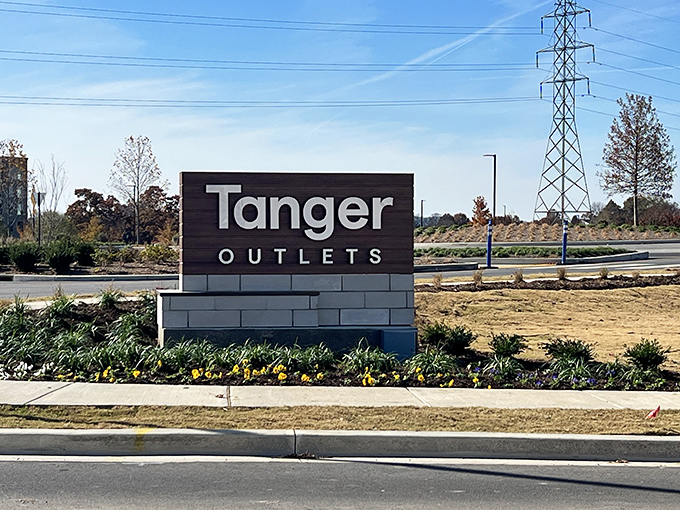 The gateway to bargain bliss. Tanger's understated entrance sign belies the wallet-friendly wonderland that awaits beyond.