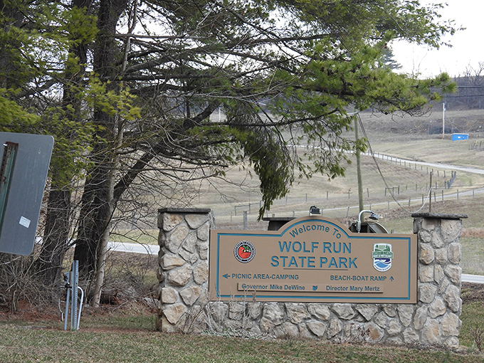 The gateway to adventure. This unassuming entrance sign marks the boundary between ordinary life and Wolf Run's natural escape.