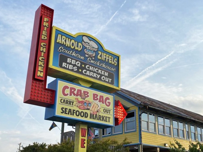 The roadside sign stands tall like the seafood equivalent of Vegas lights, beckoning hungry travelers with promises of crustacean nirvana.