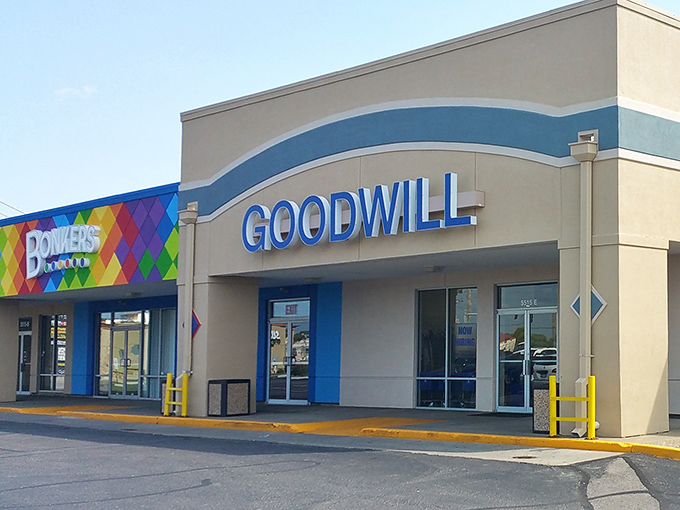 The bright Goodwill sign beckons like a lighthouse for the budget-conscious, promising treasures within for those willing to hunt.
