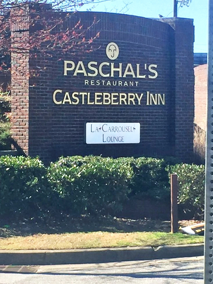 The Castleberry Inn sign stands sentinel, marking the spot where history and hospitality have been shaking hands since 1947.