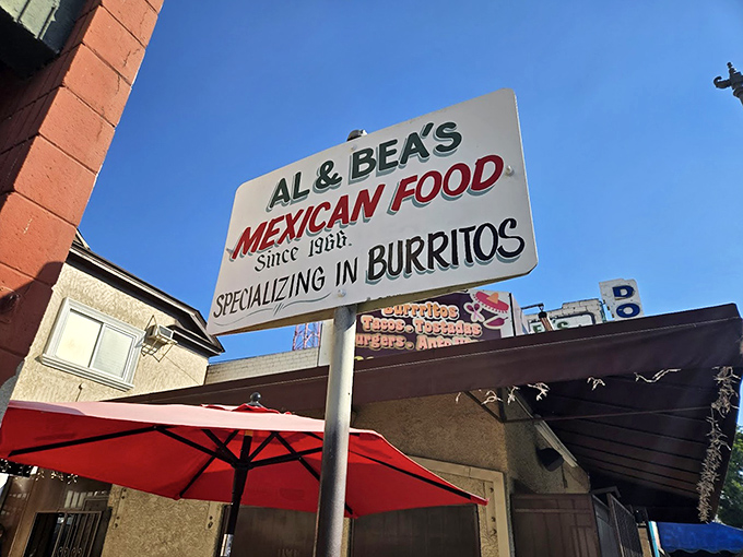"Specializing in Burritos" might be the most honest advertising in Los Angeles—a sign that promises exactly what it delivers, no more, no less.