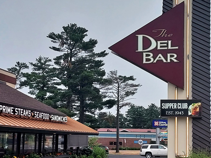 The iconic Del-Bar sign stands tall against Wisconsin skies&mdash;a burgundy triangle that points the way to steak nirvana since 1943.