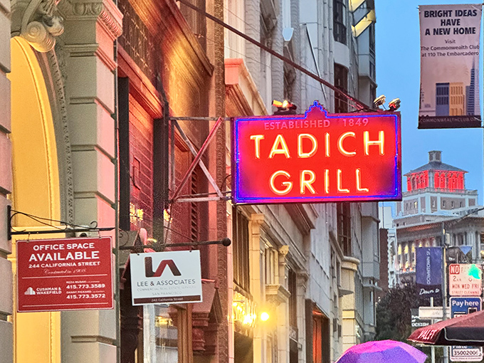 The neon sign glows against the San Francisco sky, a warm invitation to one of California's most enduring culinary institutions.