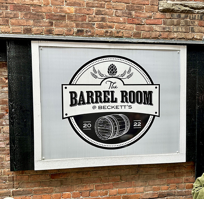 The Barrel Room sign hints at the liquid treasures waiting inside this brick-walled sanctuary of good times.
