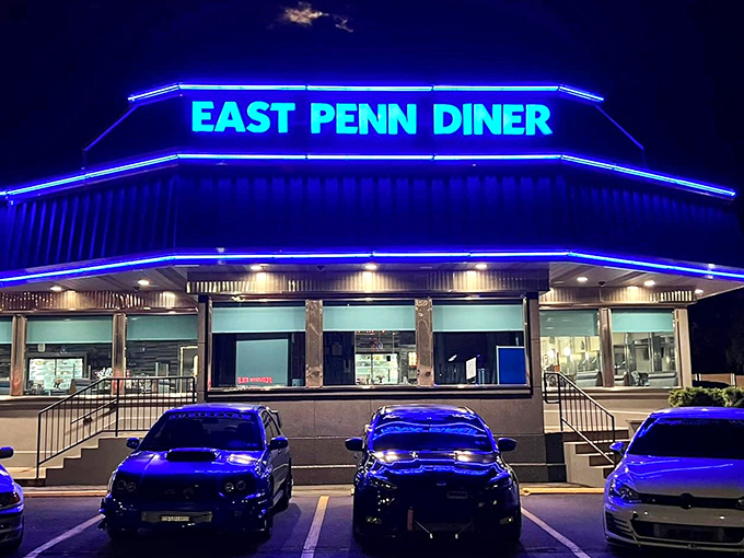 As night falls, the East Penn Diner transforms into a blue-lit beacon for hungry night owls. Some say diners look even more magical after dark.