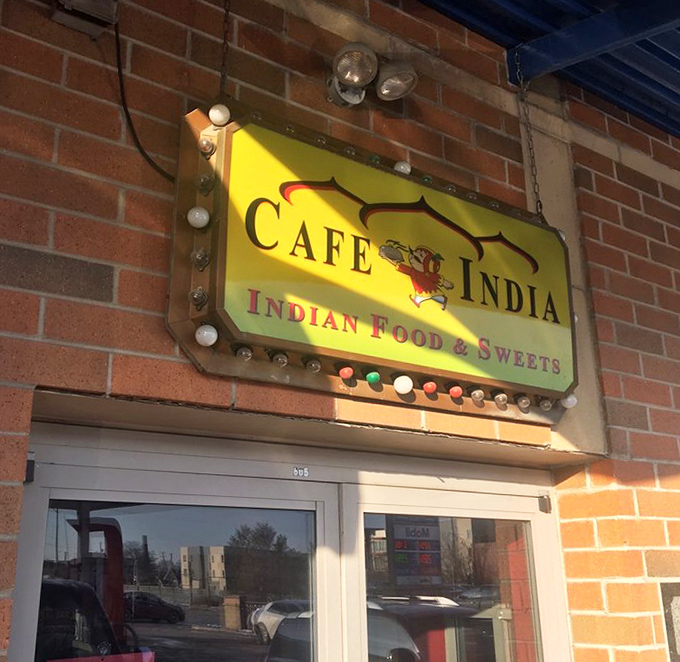 The glowing yellow sign serves as a beacon for curry seekers, its colorful bulbs like little spice indicators promising flavor ahead.