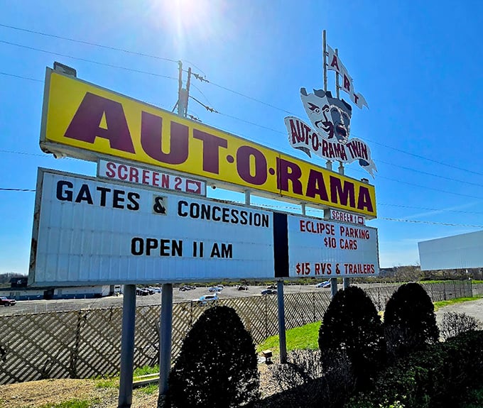 The iconic yellow and purple sign stands as a beacon for movie lovers. Like a lighthouse guiding ships, it draws film fans to shores of entertainment.