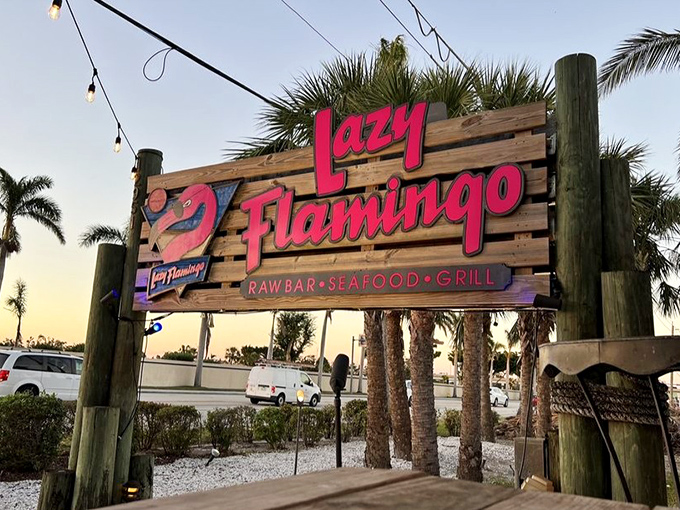A sign that promises three essential Florida food groups&mdash;Raw Bar, Seafood, and Grill&mdash;plus that sunglass-wearing flamingo who knows what's up.