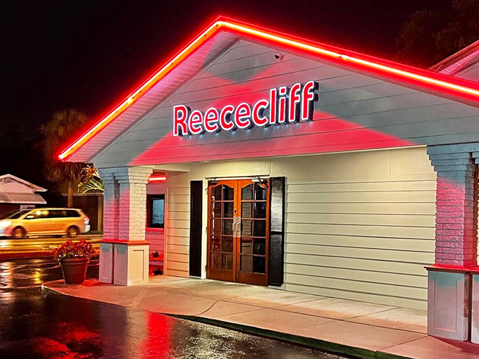 By night, Reececliff glows like a neon-trimmed promise of comfort food. The red lighting says "Yes, we're open, and yes, we have pie waiting for you."