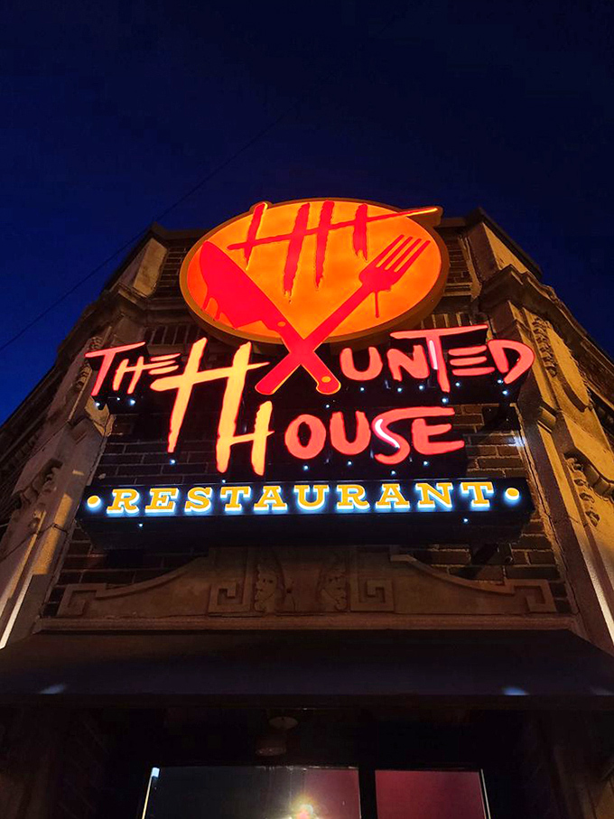 As night falls, the sign transforms into a beacon for hungry thrill-seekers. The glowing emblem promises a dining adventure where the only thing frightening is how quickly you'll clean your plate.