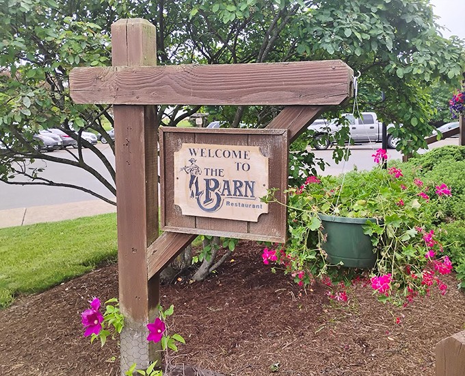 A welcome sign surrounded by flowers&mdash;nature's way of saying "the food inside is worth the calories you're about to consume."