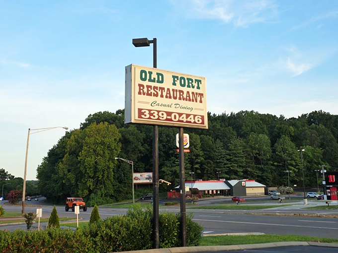 The roadside sign stands tall like a tasty lighthouse, guiding hungry travelers to what might be the best breakfast decision they'll make all day.