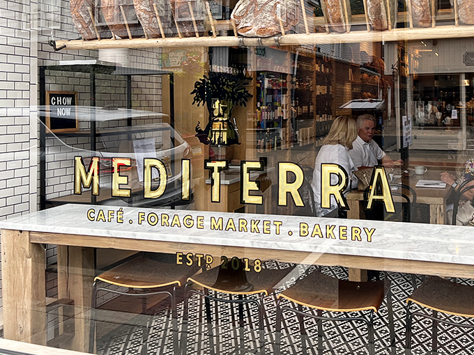 The window announces its triple identity with golden confidence: caf&eacute;, market, bakery. It's not being greedy &ndash; it's being gloriously ambitious.