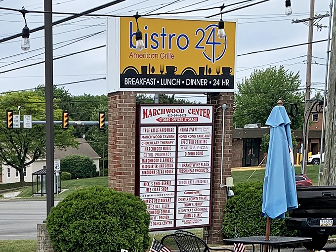 The sign stands tall, a beacon of hope for the hungry. "Breakfast-Lunch-Dinner-24 HR" reads like poetry to those with empty stomachs.
