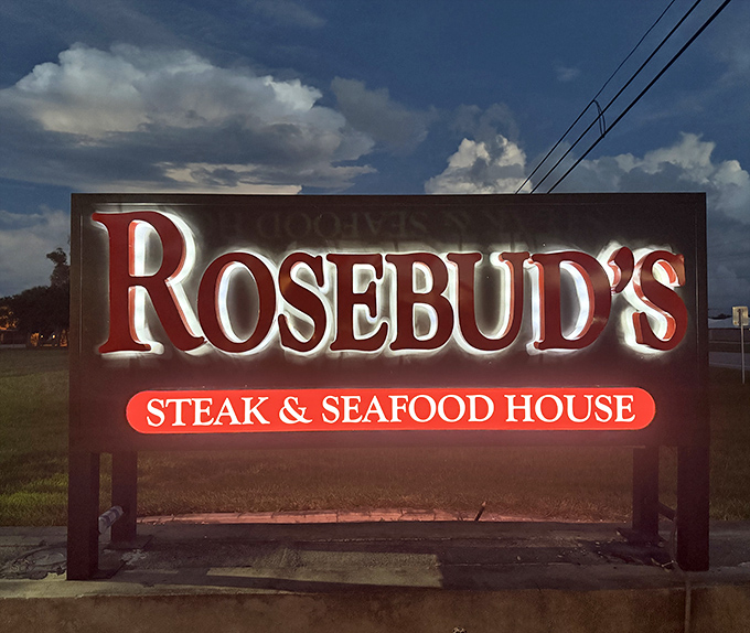 The sign glows like a beacon for hungry travelers. At dusk, it transforms from restaurant signage to a promise of satisfaction ahead.